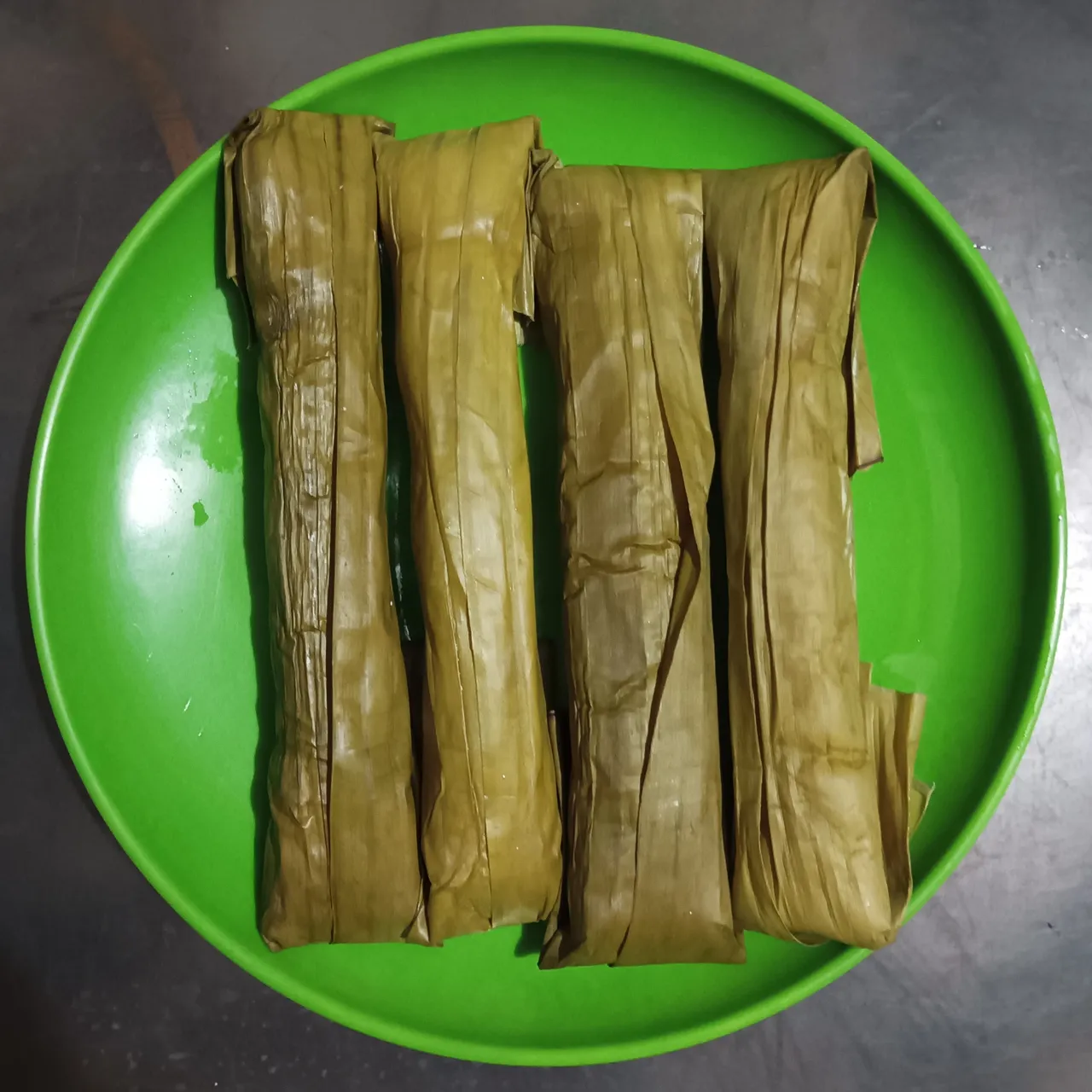 Cassava rolls wrapped with banana leaves